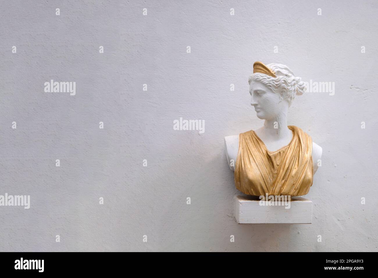 Antique head bust of woman against gray wall. Historical statue in ...