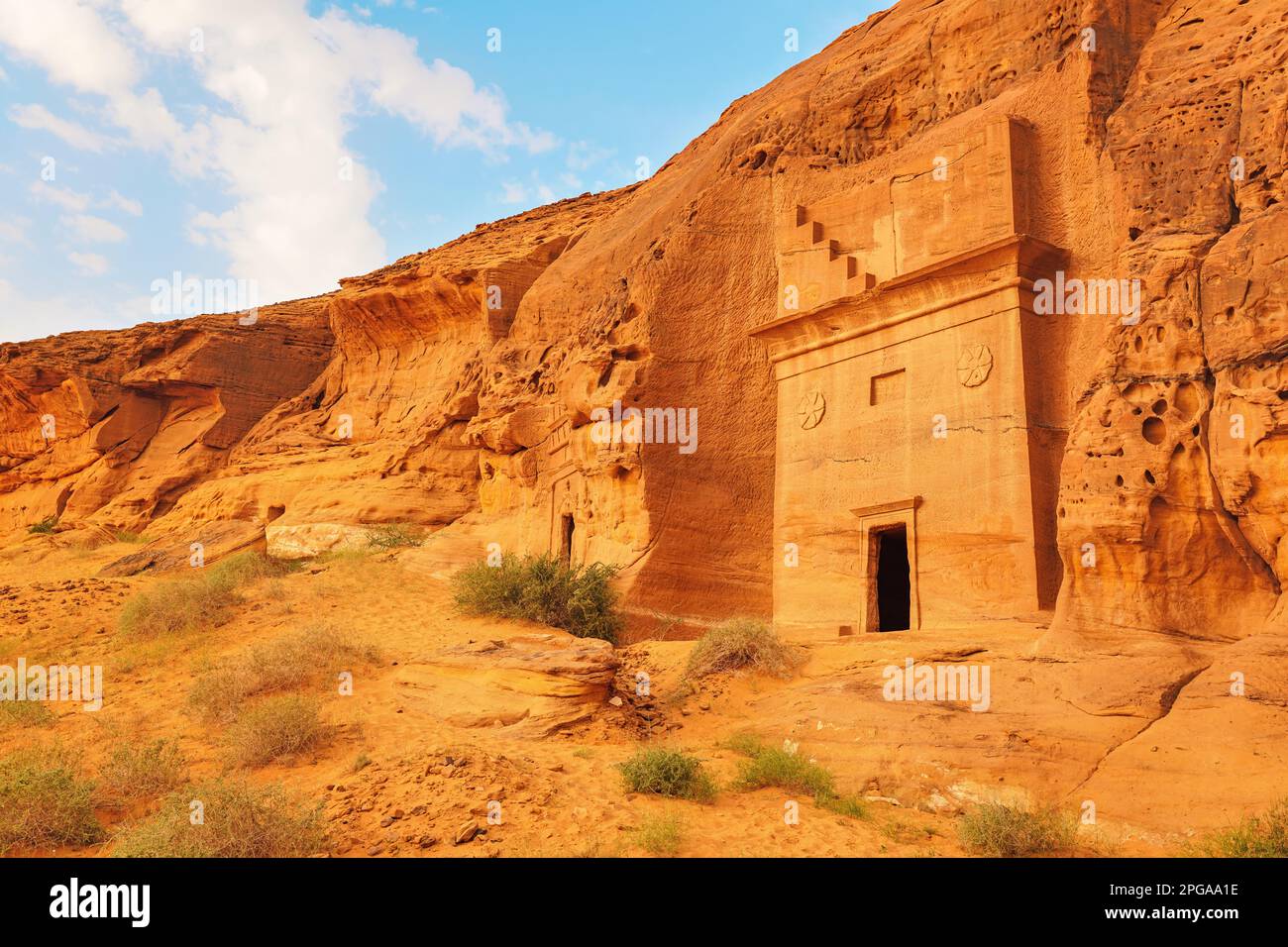 Old Nabatean architecture carved on orange sandstone wall at Jabal Al ...