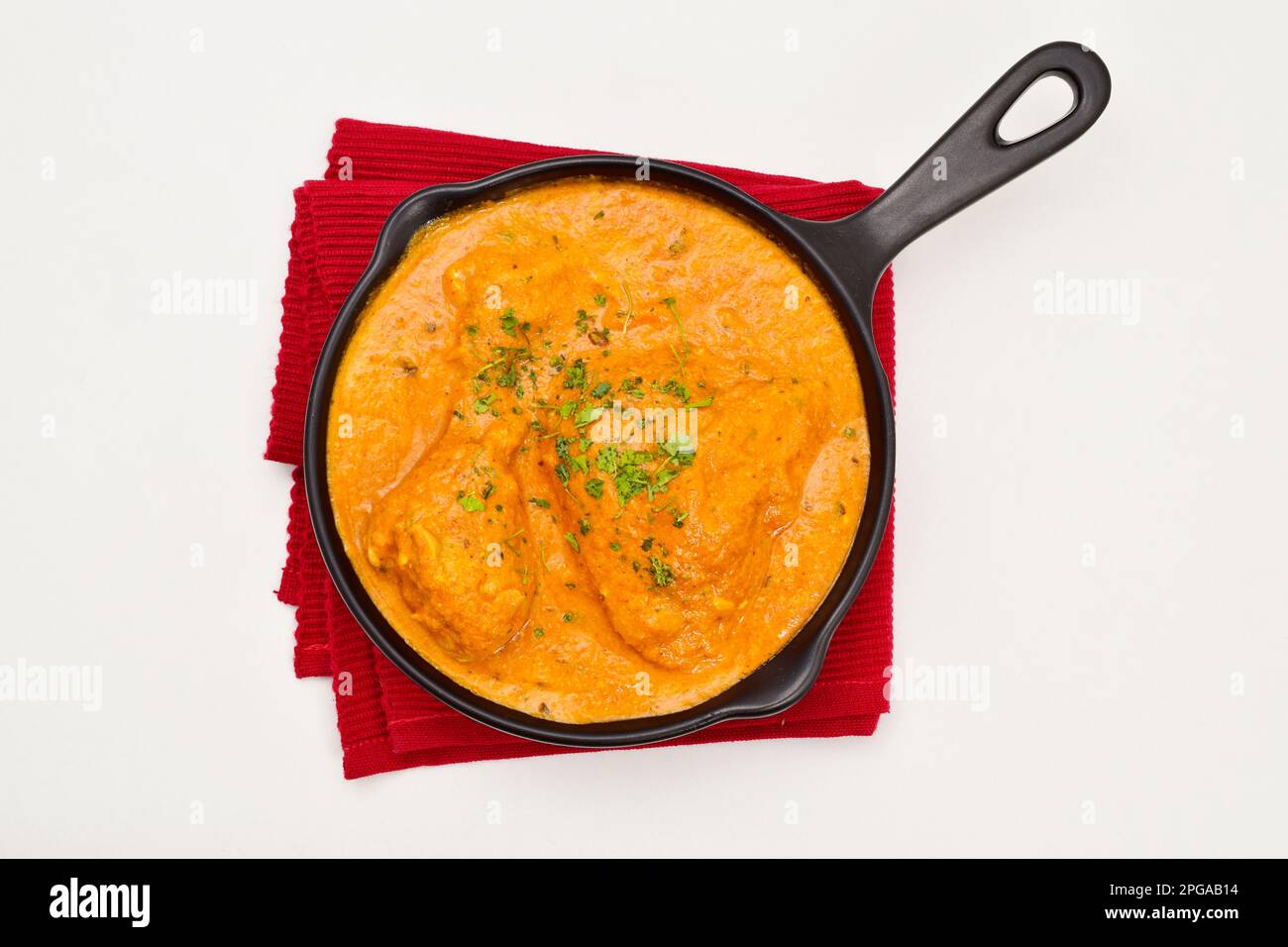 Homemade butter chicken on white background top view Stock Photo - Alamy