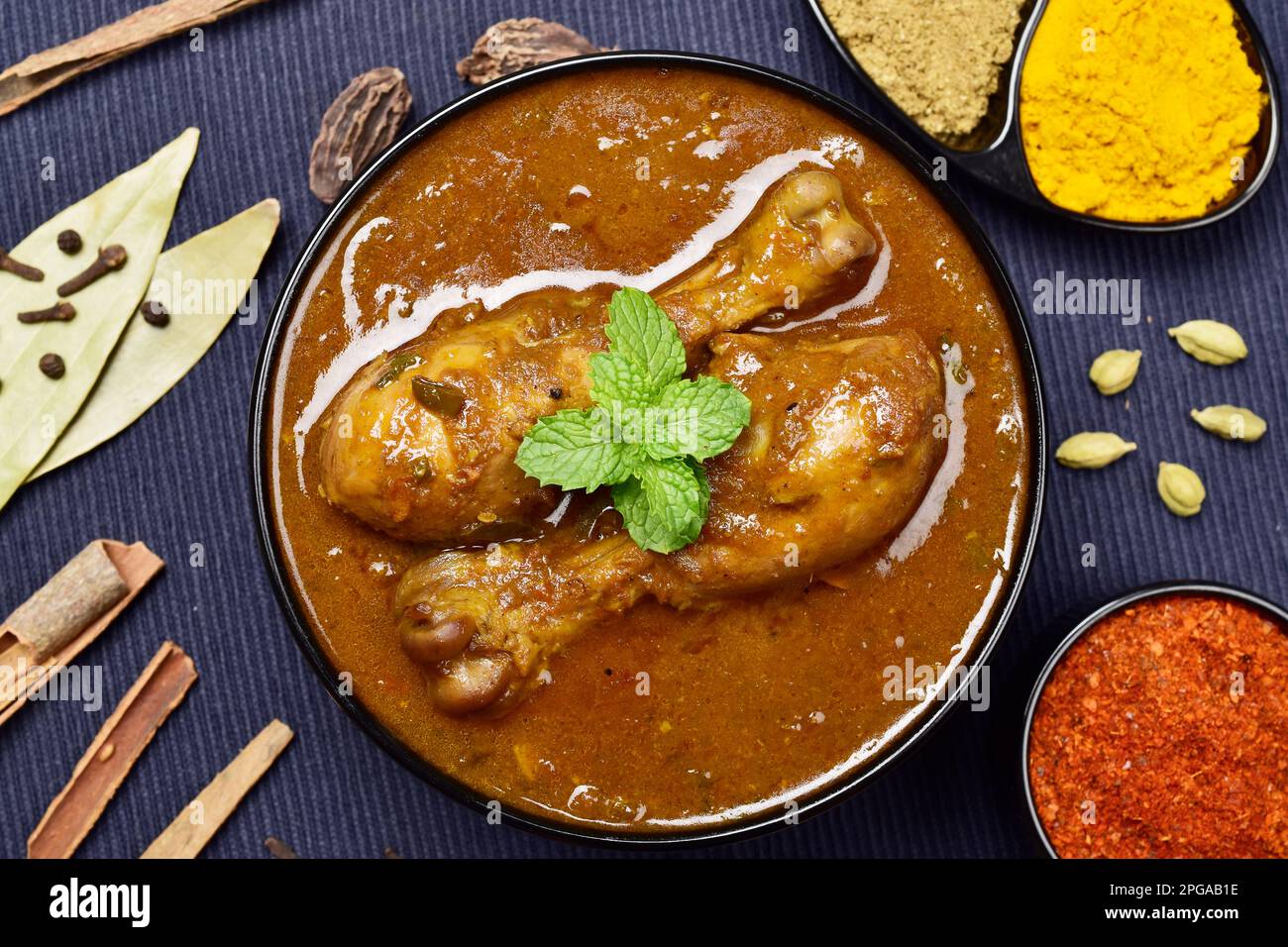 Spicy chicken curry top view, whole spices Stock Photo - Alamy