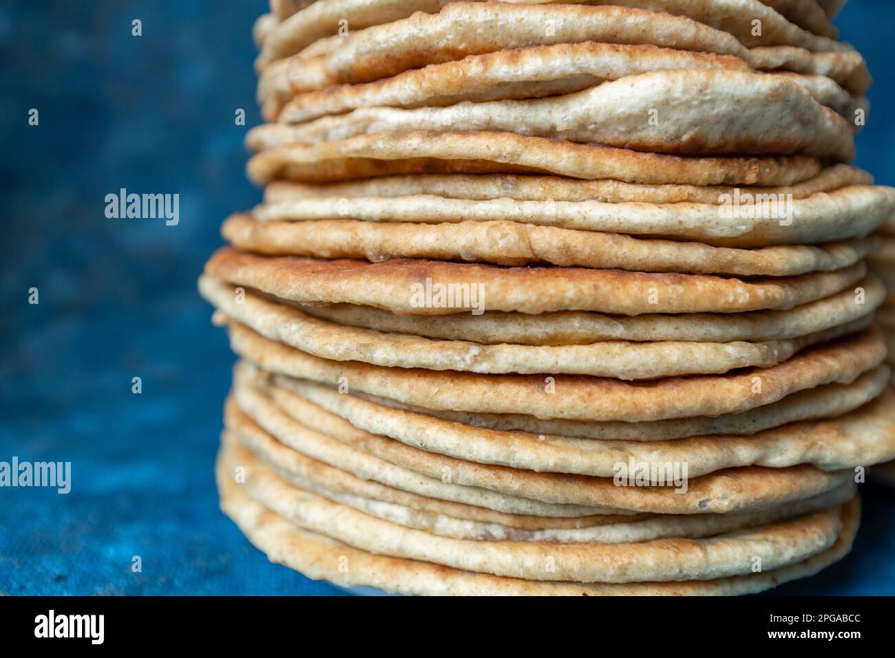 Flatbread lavash, chapati, naan, heap of tortilla on a blue background ...