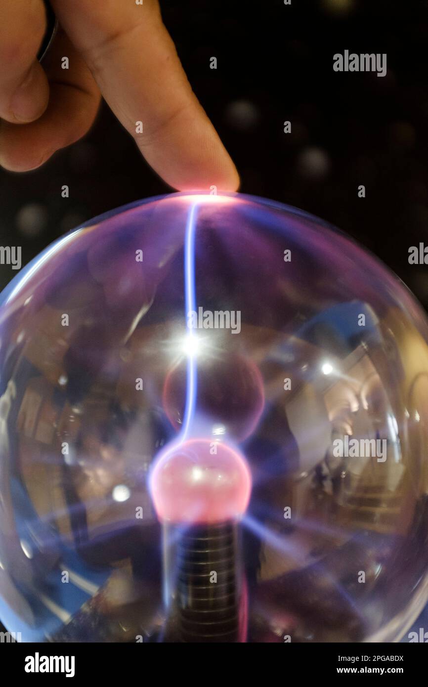 Electricity lighting ray going to a finger hand on a powerful spark ...