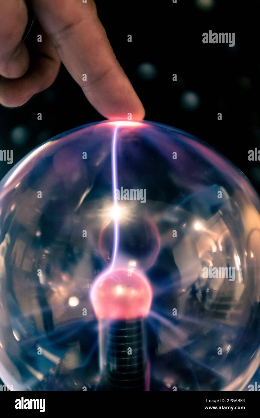 Electricity lighting ray going to a finger hand on a powerful spark ...