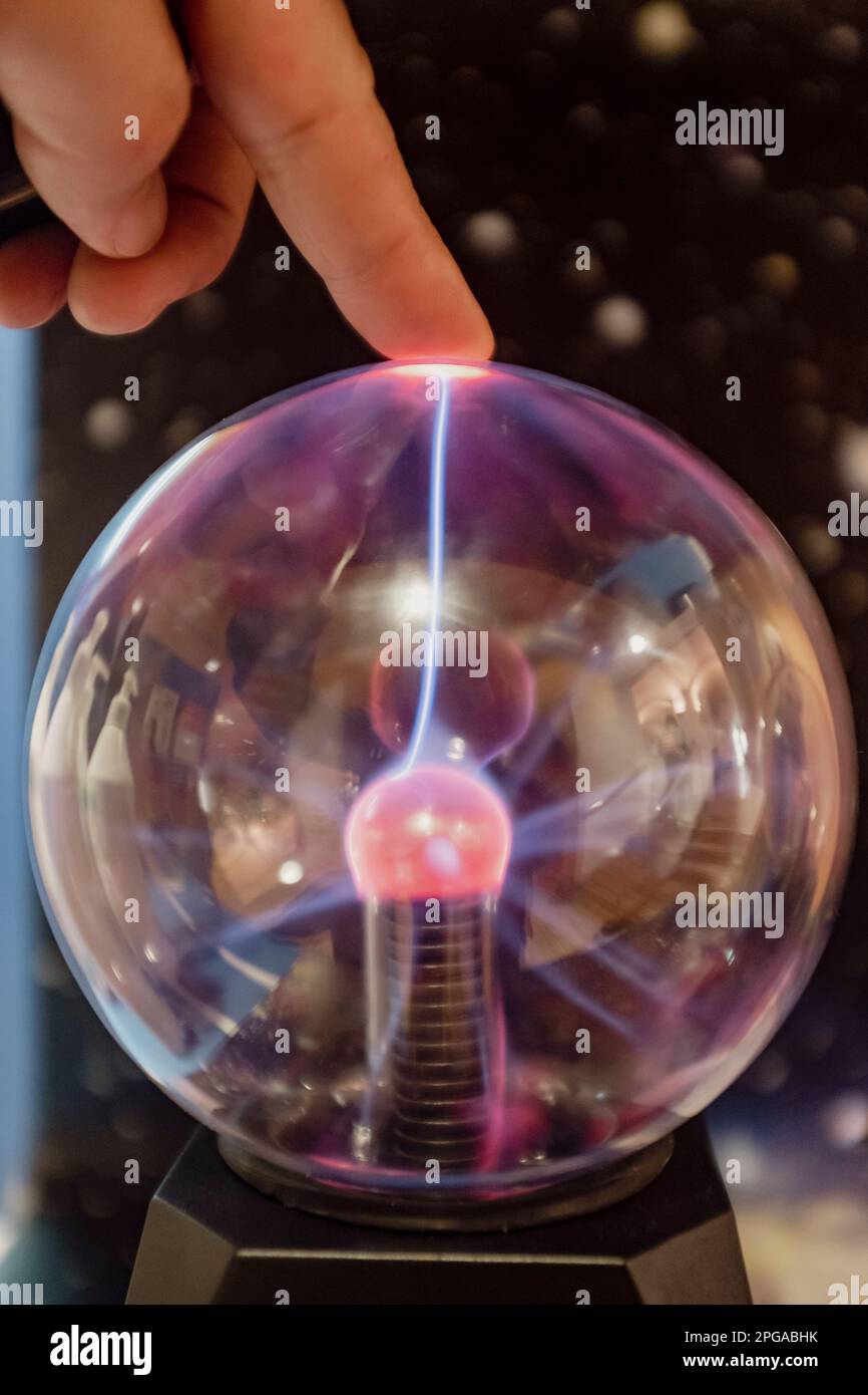 Electricity lighting ray going to a finger hand on a powerful spark ...