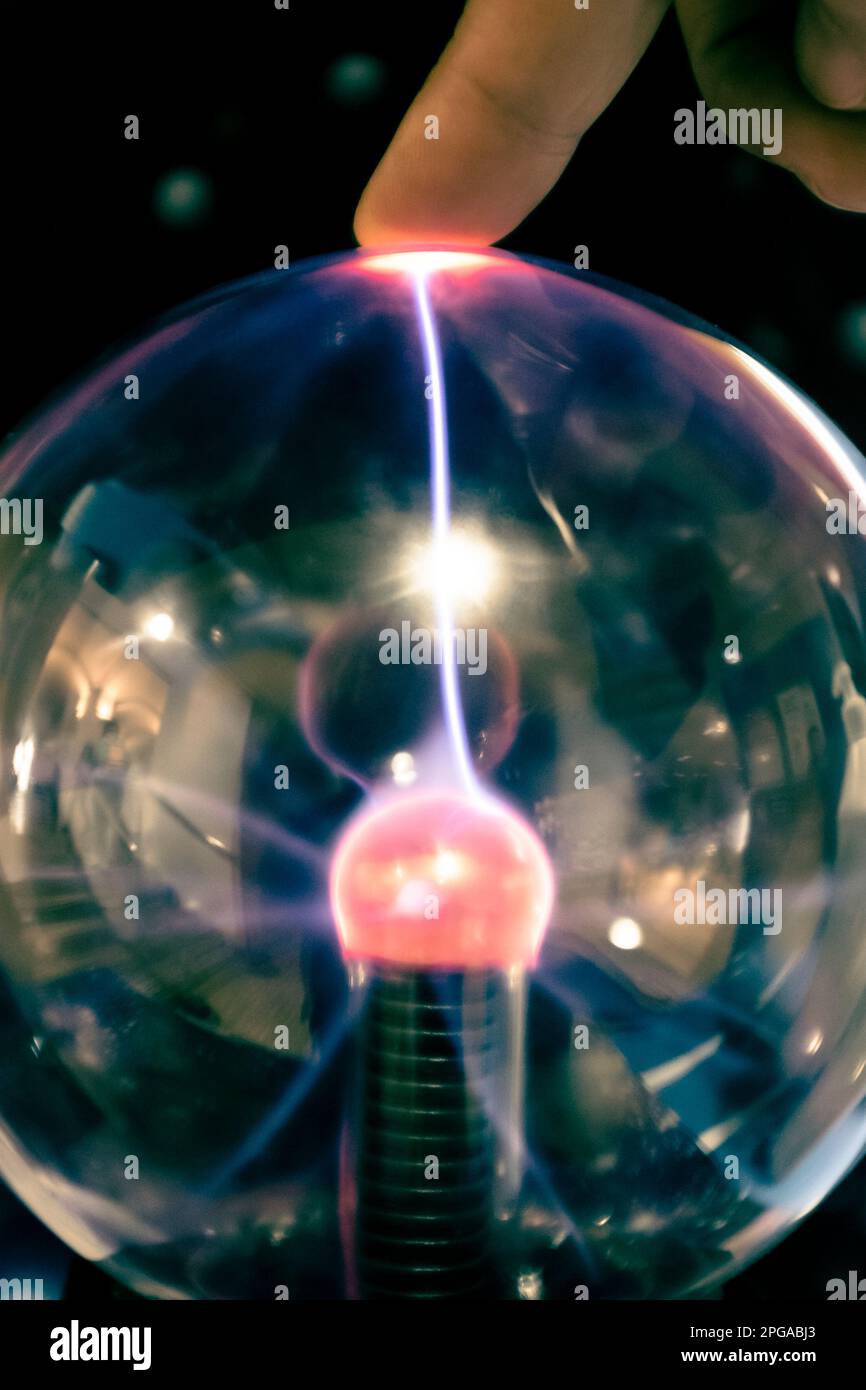 Electricity lighting ray going to a finger hand on a powerful spark ...