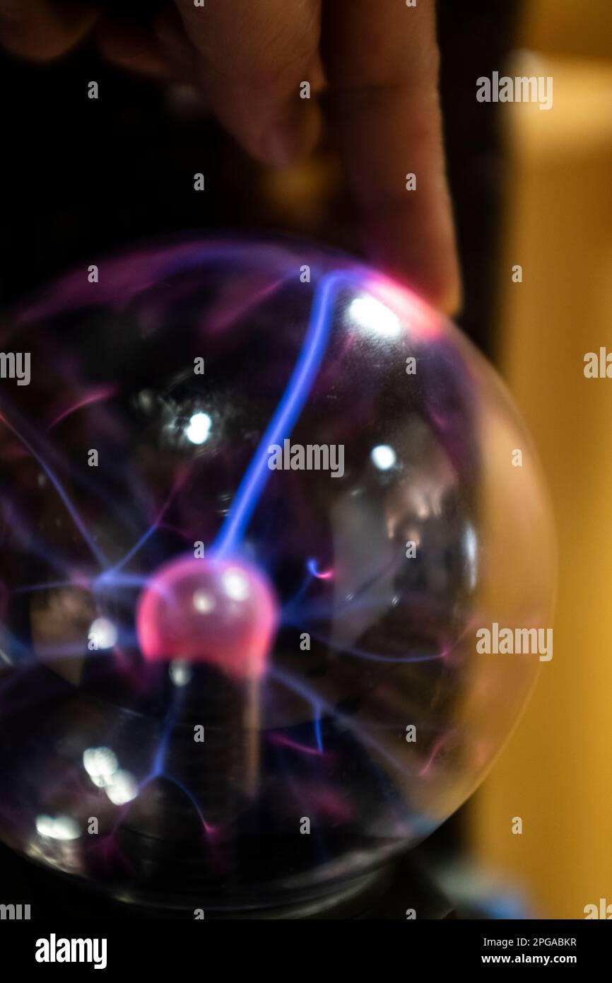 Electricity lighting ray going to a finger hand on a powerful spark ...