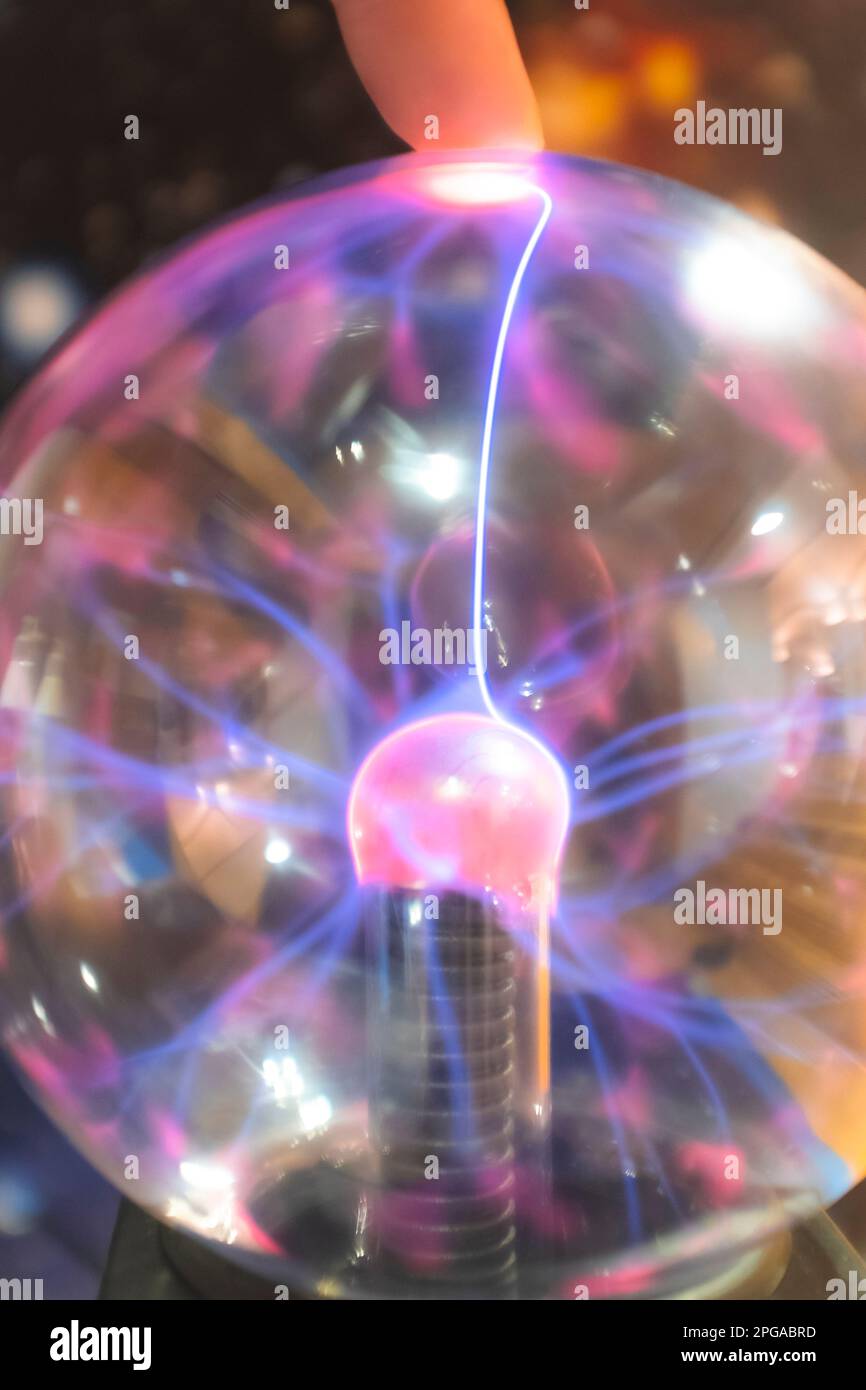 Electricity lighting ray going to a finger hand on a powerful spark ...