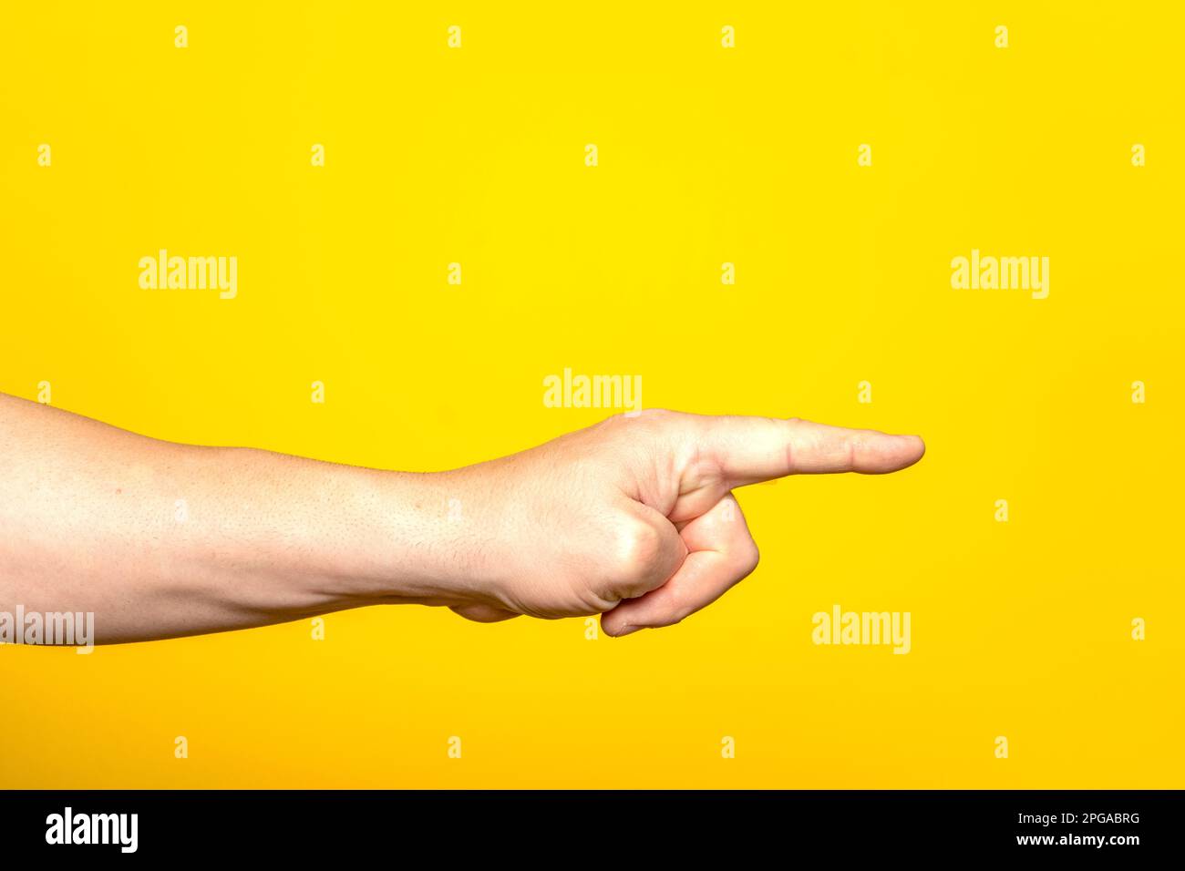 Man's hand pointing at something with the index finger, isolated on ...