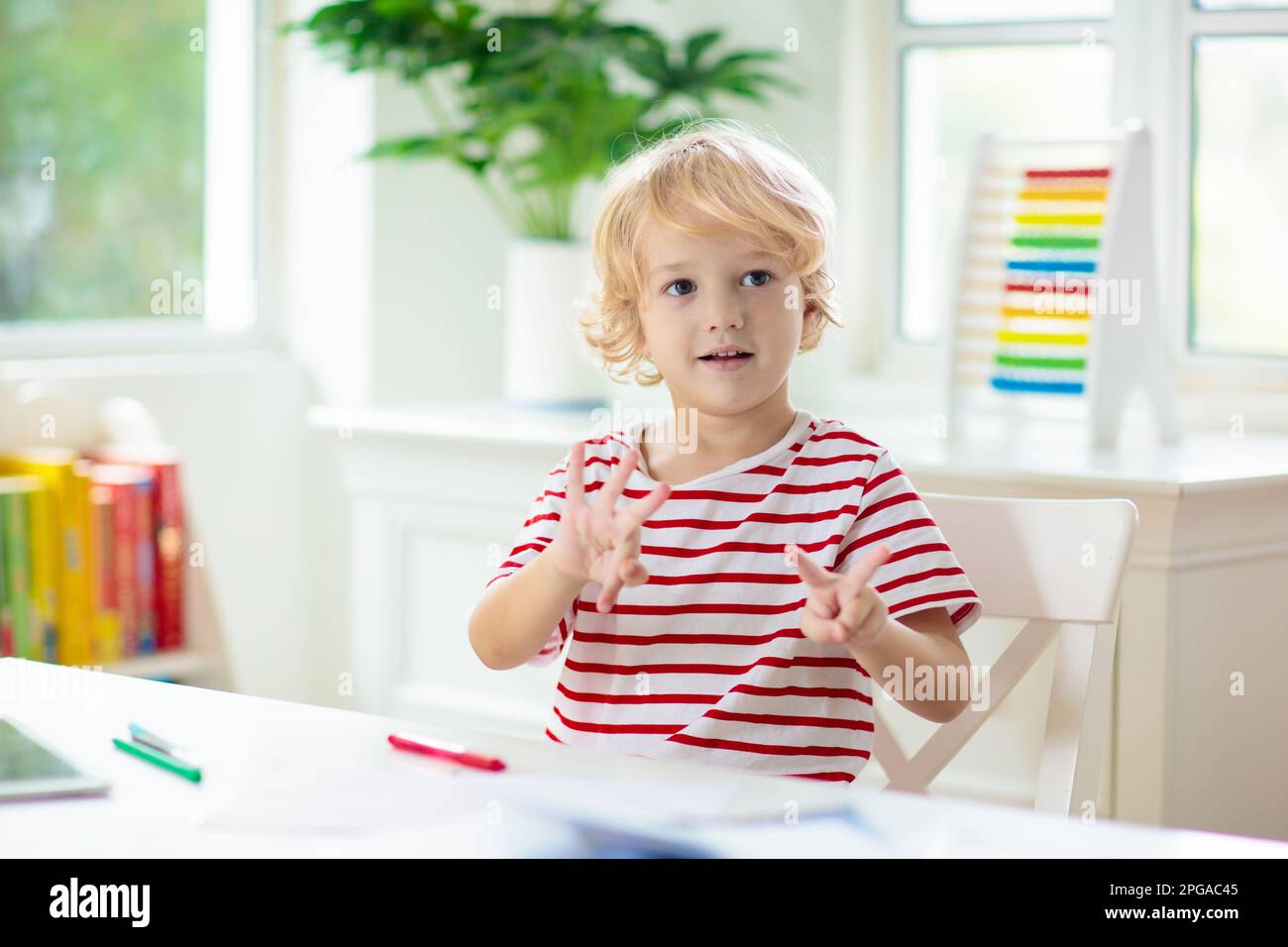 Little boy learning numbers. Kindergarten kid doing math homework ...