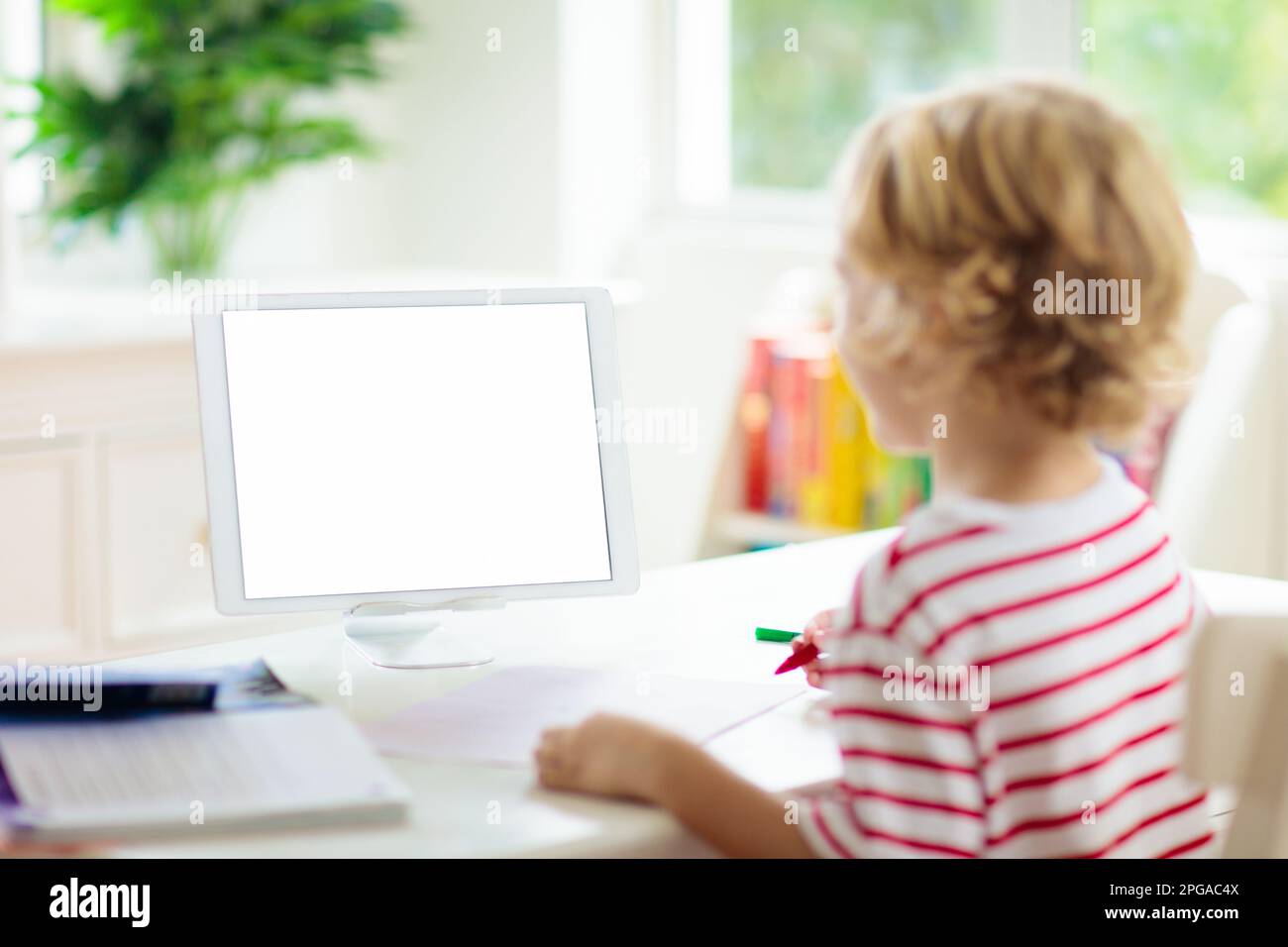 School child doing homework. Empty laptop screen. Blank copy space on ...