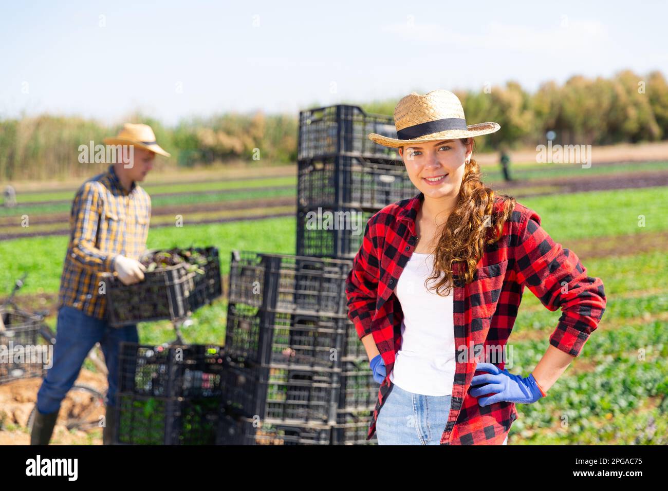 Portrait of an experienced positive female farmer in backyard of farm ...