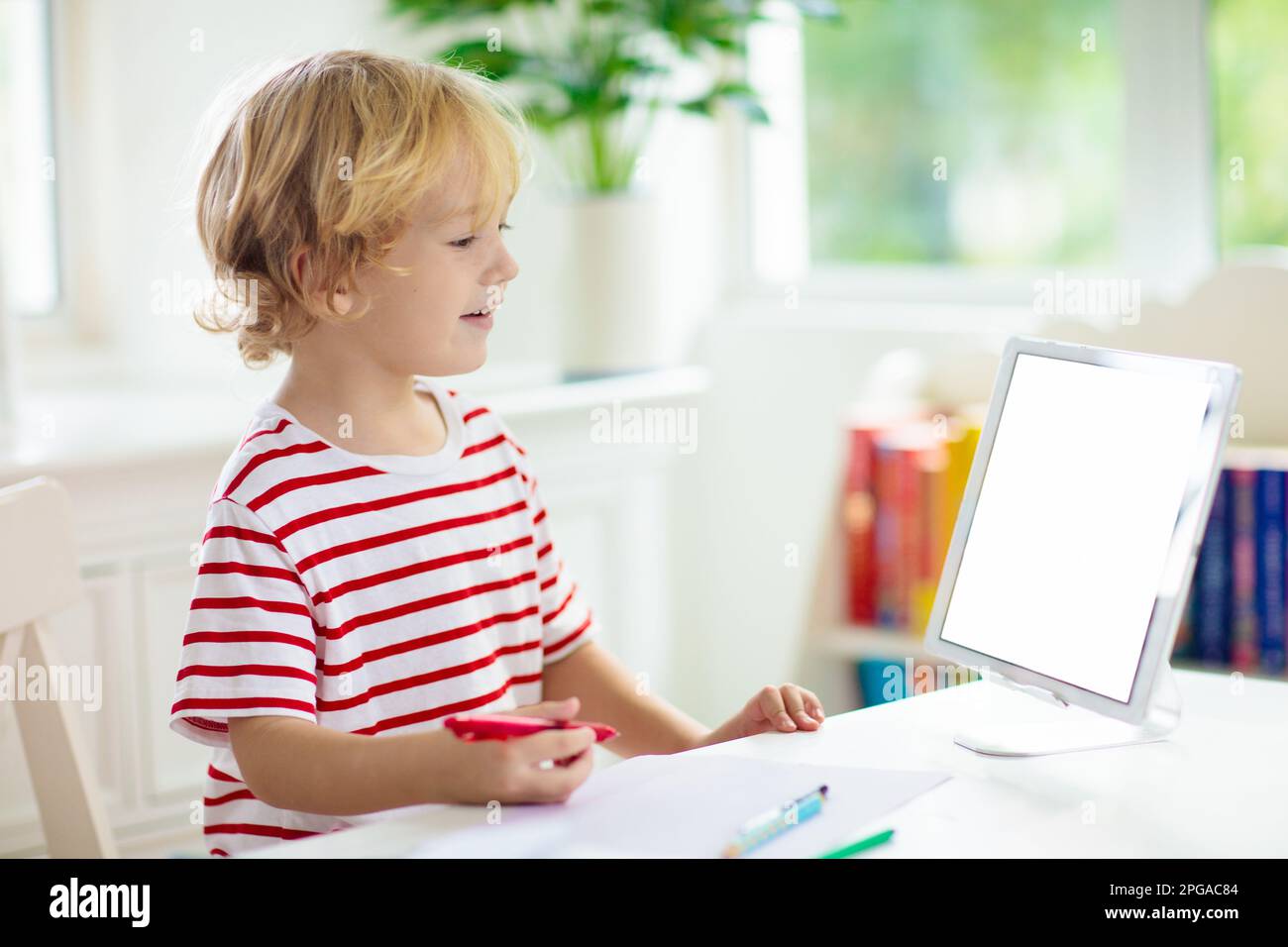 School child doing homework. Empty laptop screen. Blank copy space on ...