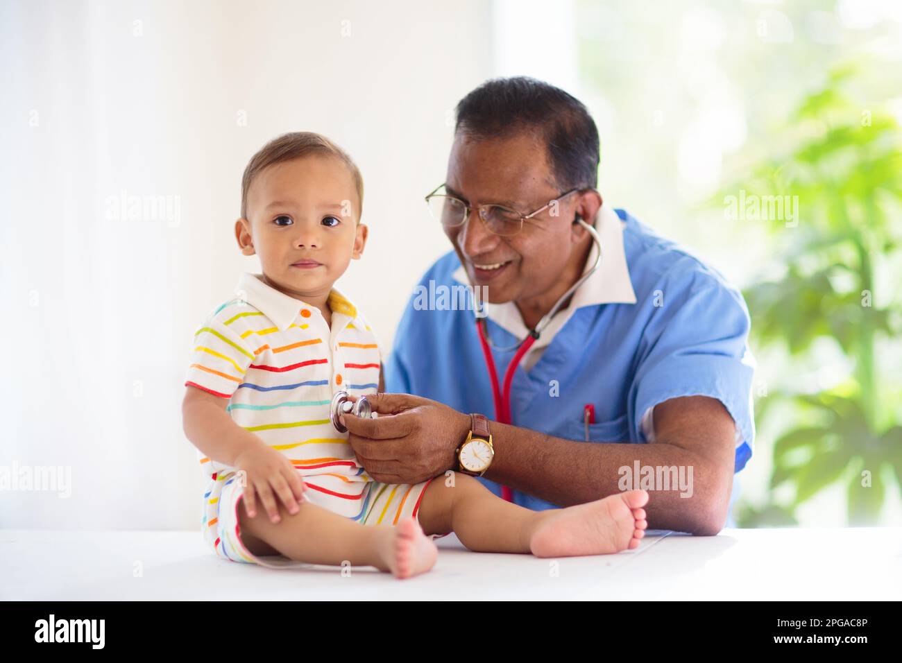 Pediatrician doctor examining baby. Asian boy in health clinic for test ...