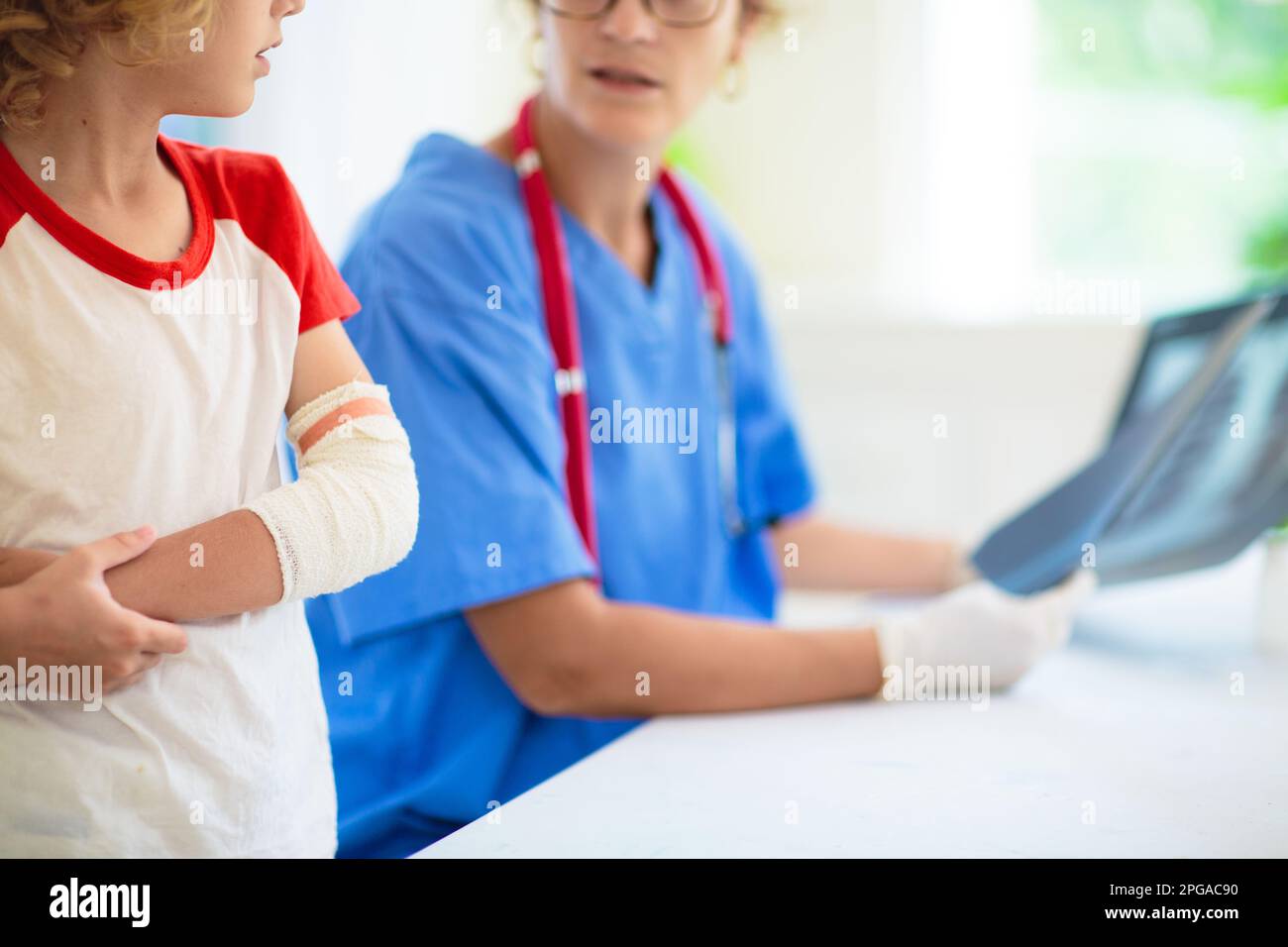 Child with arm injury at trauma and emergency care. Kid with elbow cast ...
