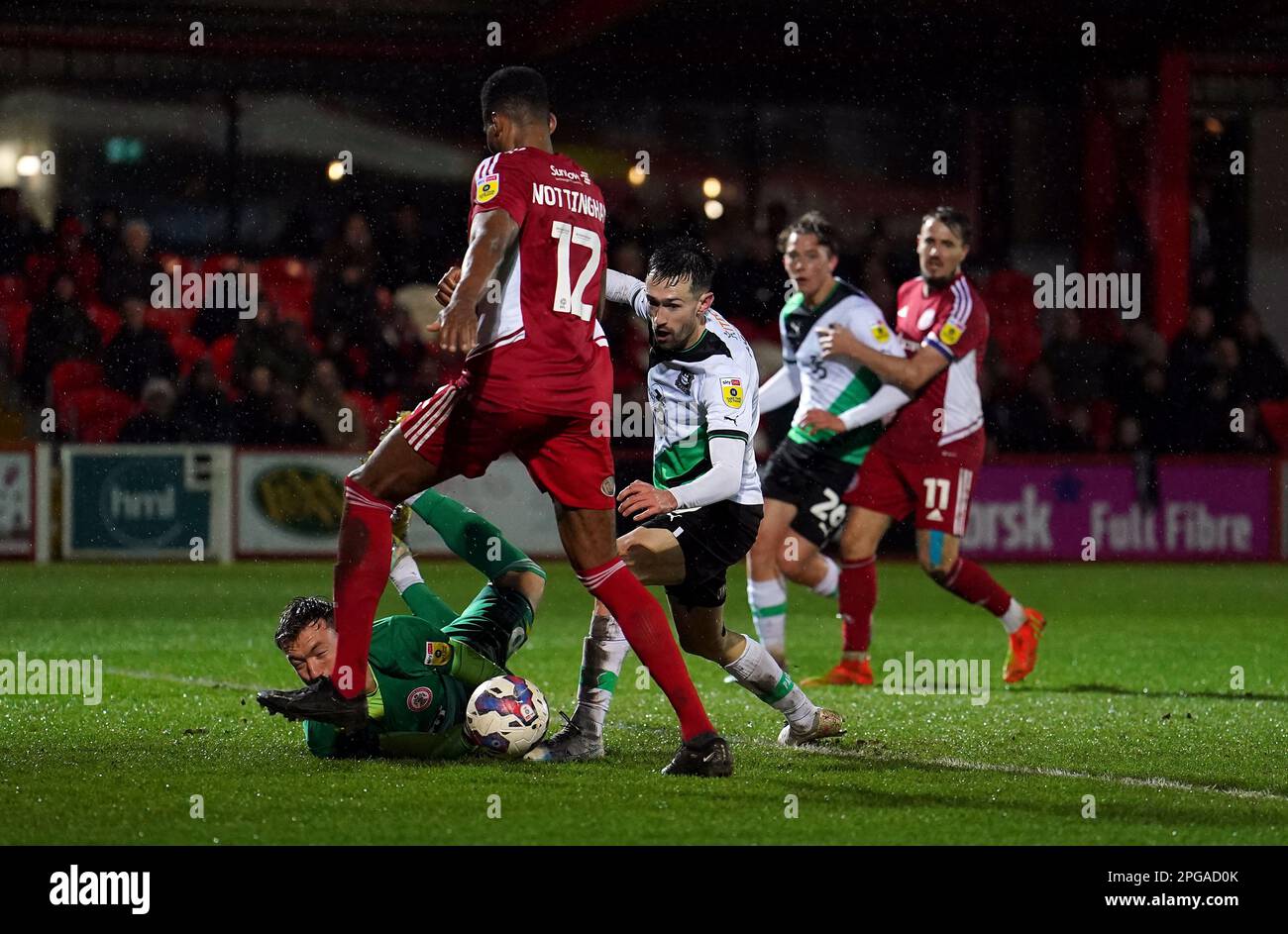 Accrington Stanley' goalkeeper Toby Savin makes a save at the feet of ...