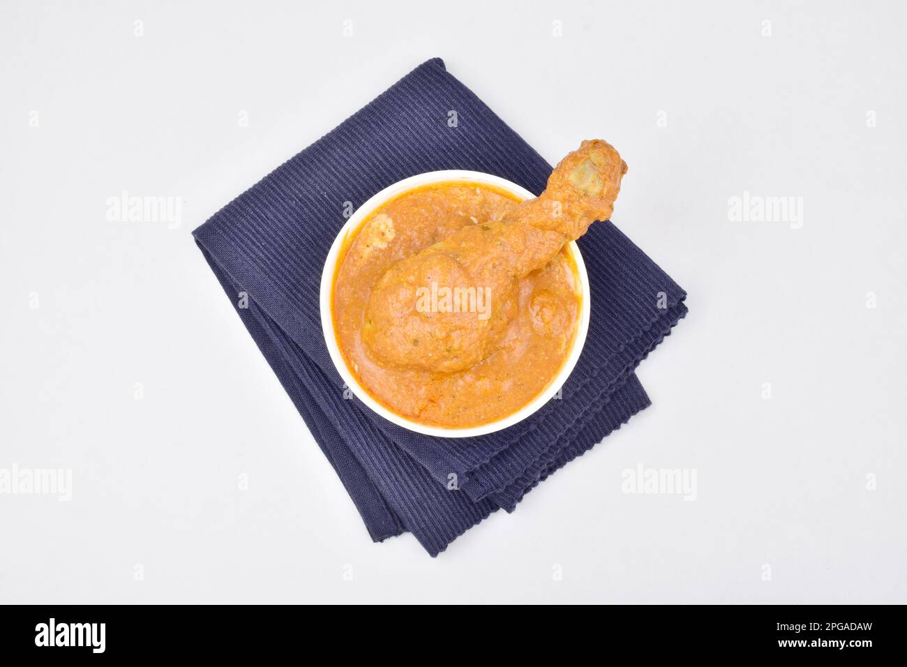 Top view of butter chicken in small bowl on white background Stock ...