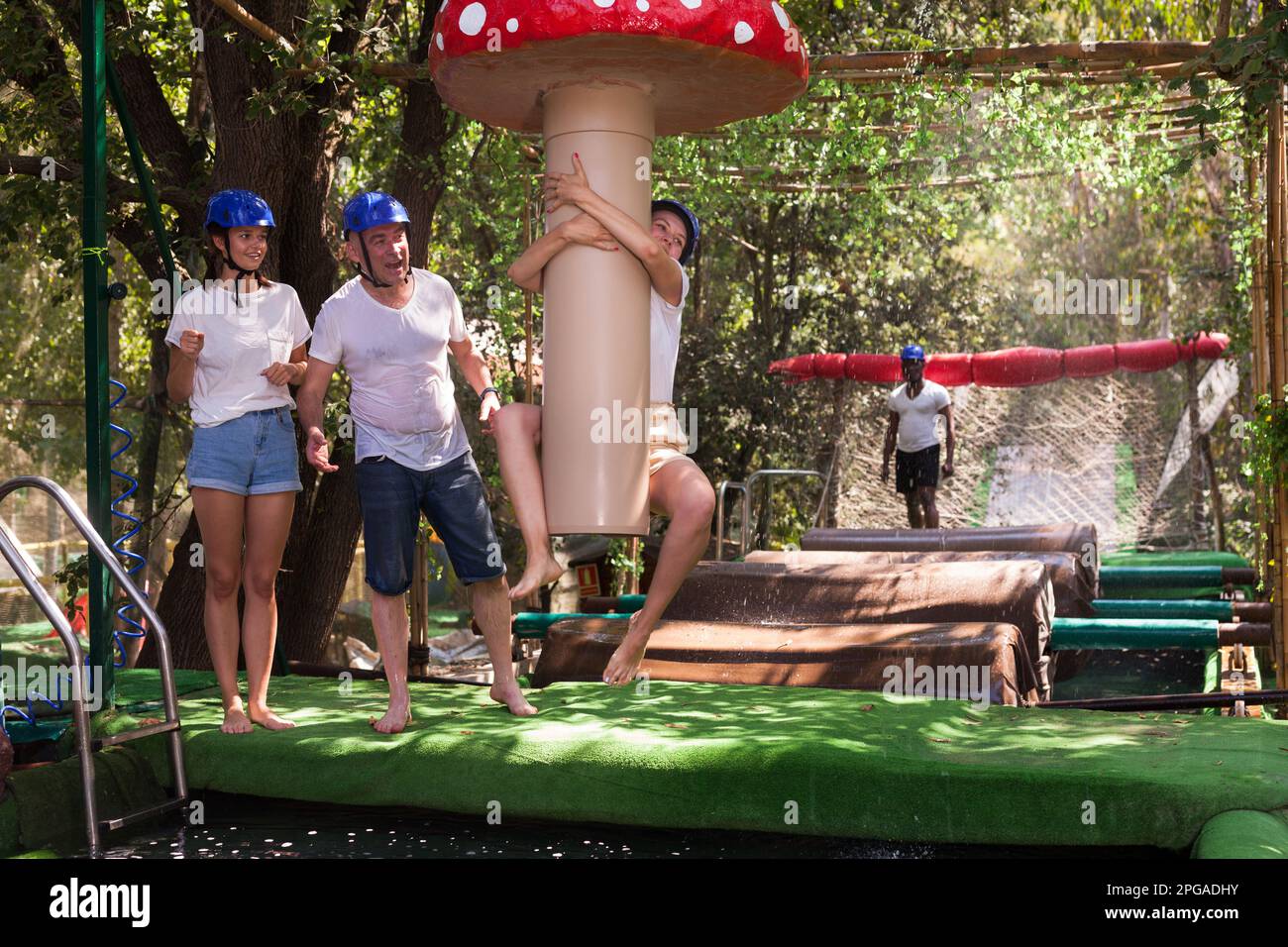 Men and women having fun at adventure park Stock Photo - Alamy