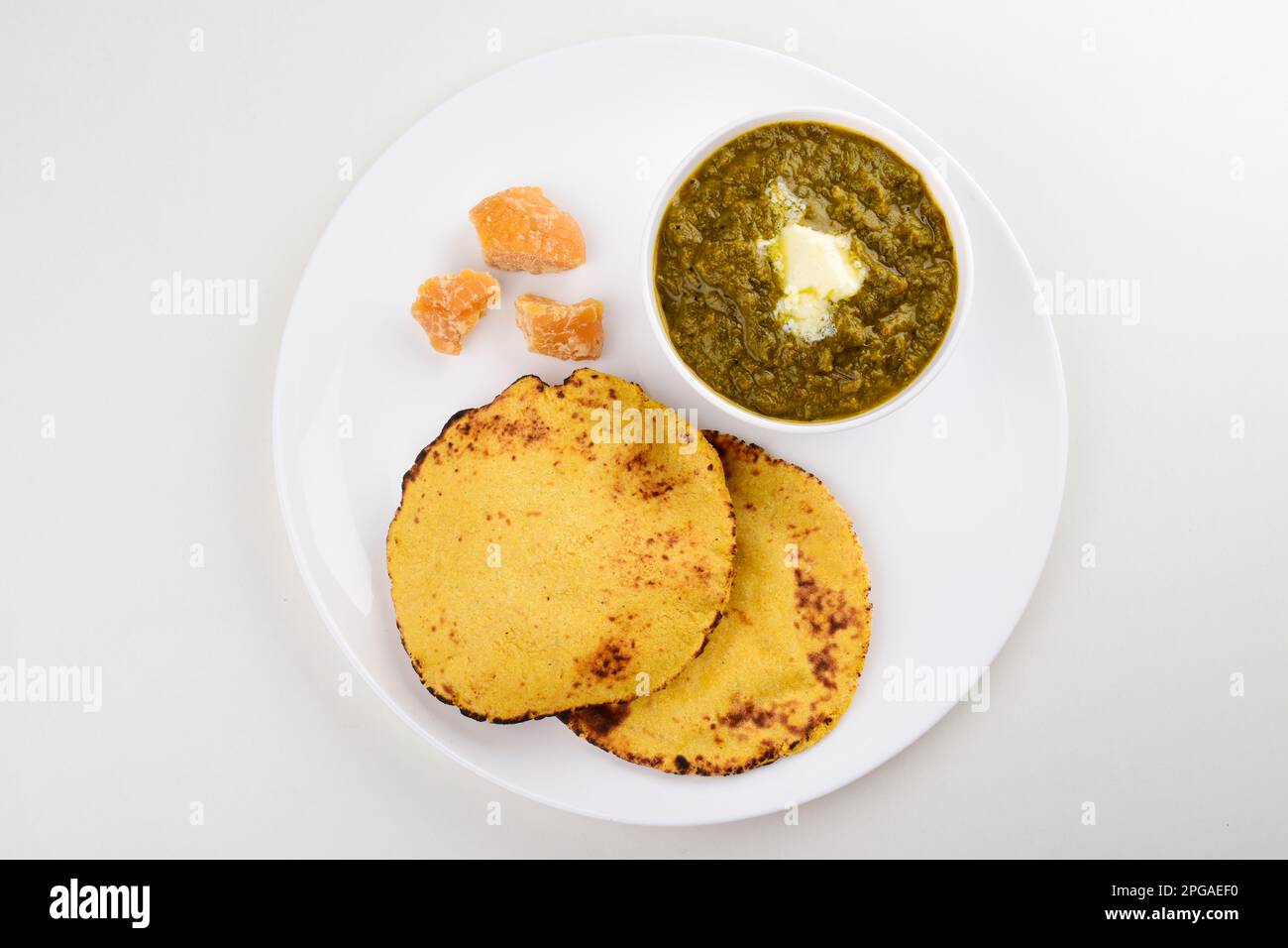 Top view of sarson ka saag with makki roti and jaggery Stock Photo - Alamy