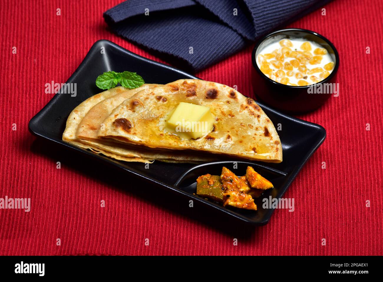 Paratha served with raita and achar Stock Photo - Alamy