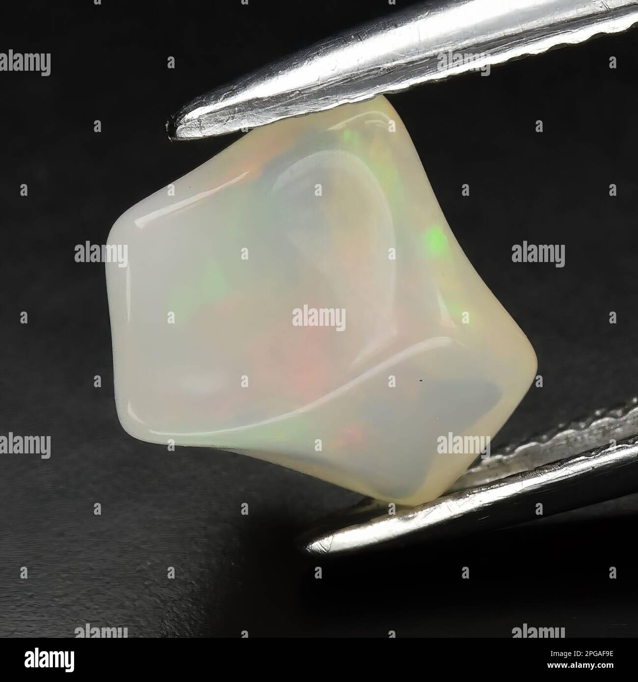 Natural precious stone opal on a black background Stock Photo - Alamy