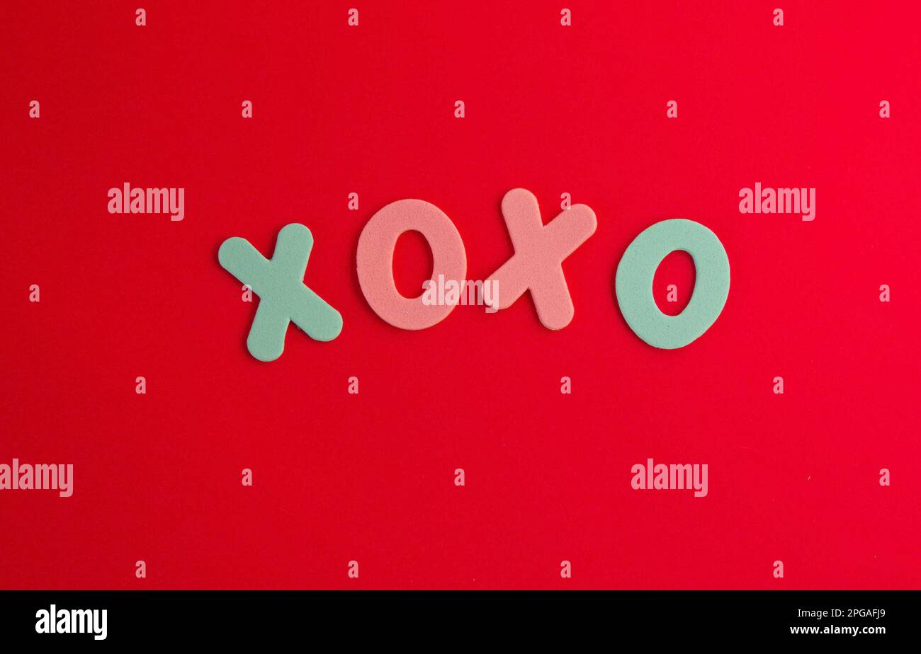 The inscription xo xo from colored letters on a red background. The ...