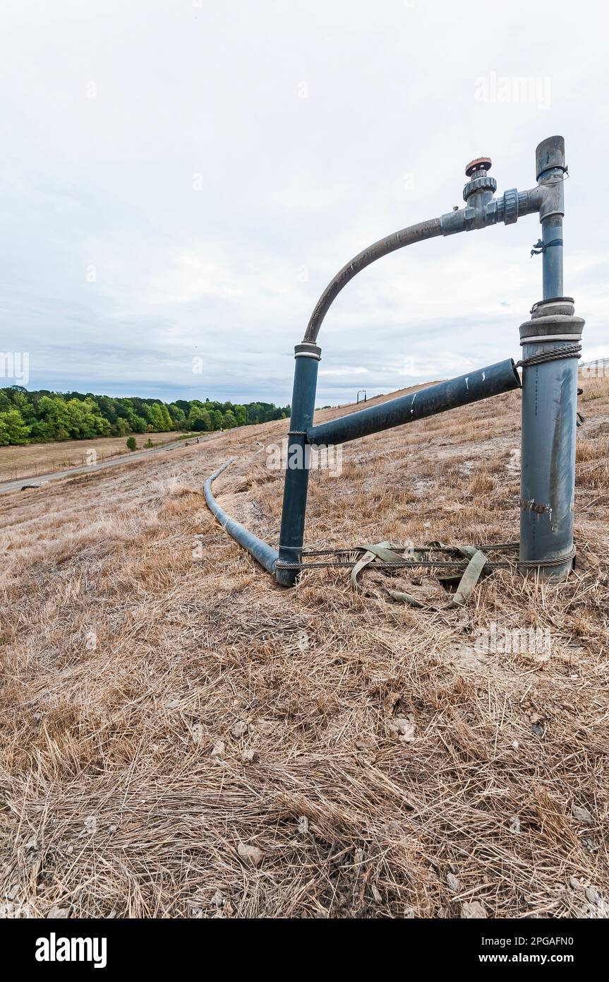A vertical landfill methane gas wellhead and valve at an active ... A vertical landfill methane gas wellhead and valve at an active ...