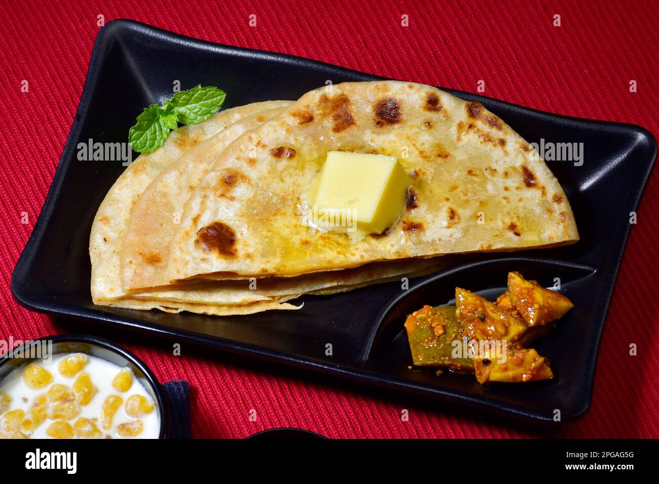 Stuffed paratha with butter and aam ka achar Stock Photo - Alamy