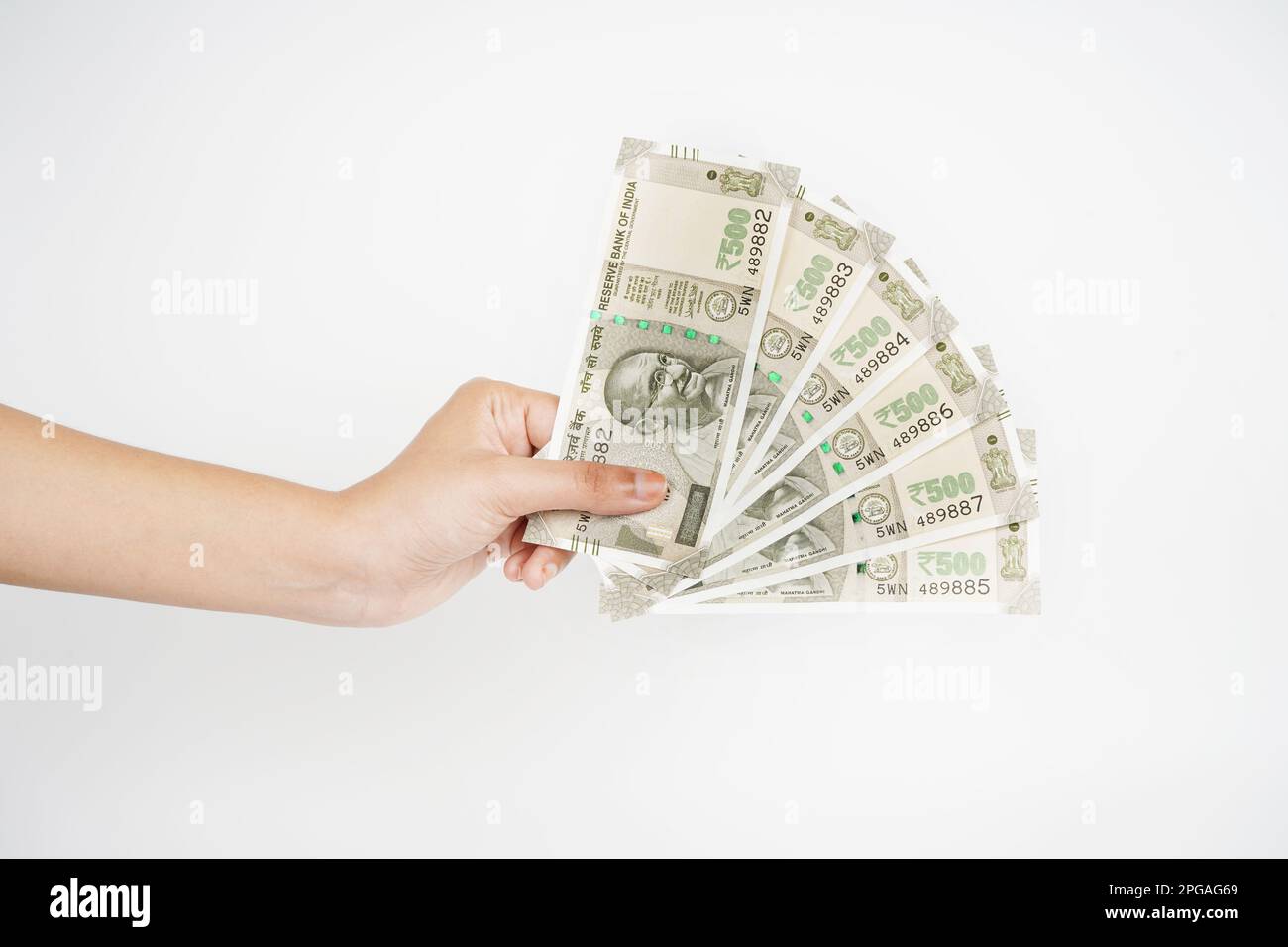 Rupees in hand on white background, indian currency note Stock Photo ...