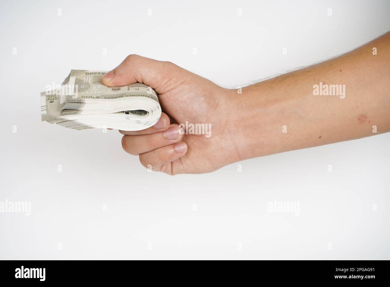 Cash bundle in hand on white background, indian rupees note Stock Photo ...