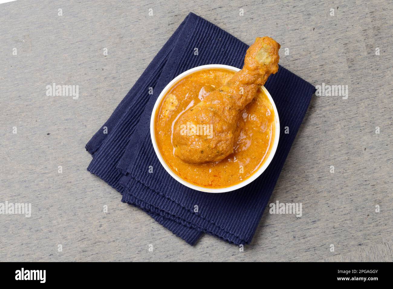 Butter chicken with leg piece in small bowl top view Stock Photo - Alamy