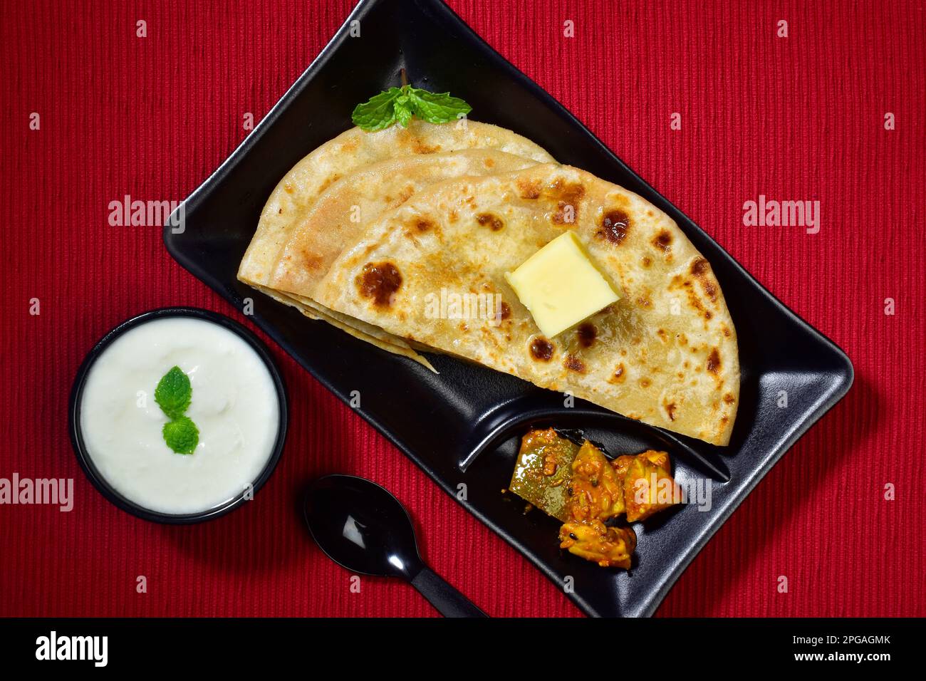 Sliced paratha with aachar and dahi top view Stock Photo - Alamy