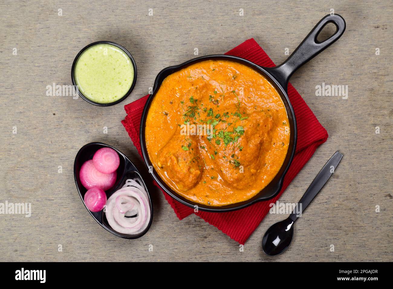 Murgh makhani or butter chicken with mint chutney and onion Stock Photo ...