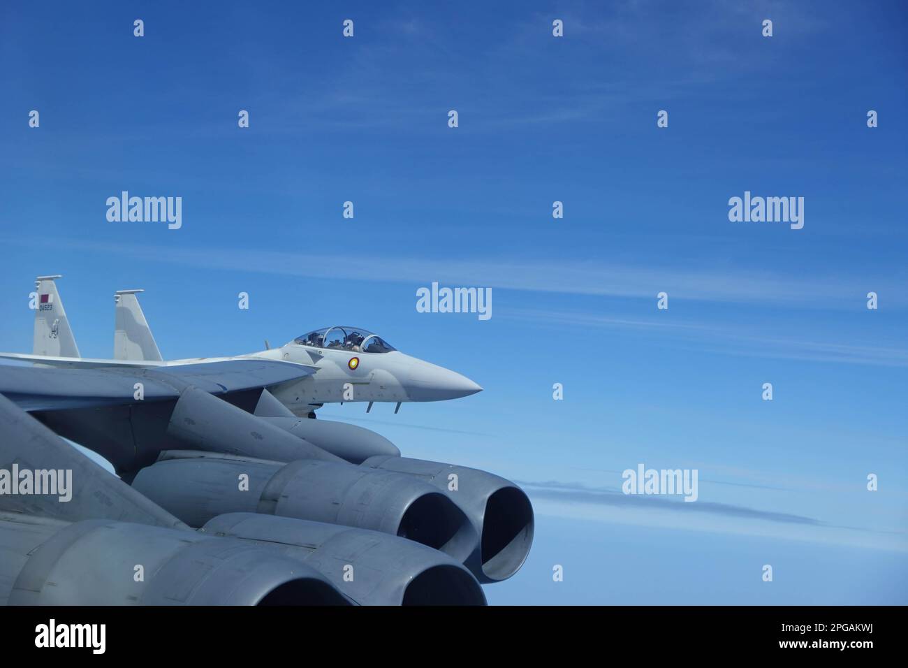 A Qatar Emiri Air Force F-15 Strike Eagle flies in formation with a B ...