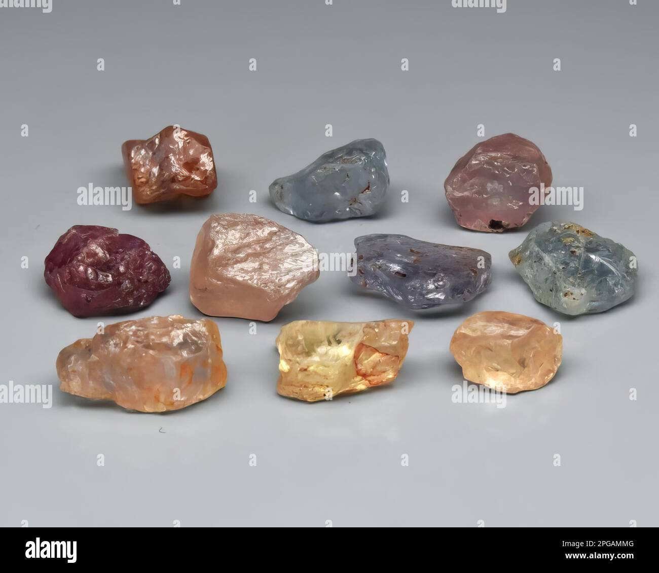 Natural gem orange Padparadscha sapphire on gray background Stock Photo ...