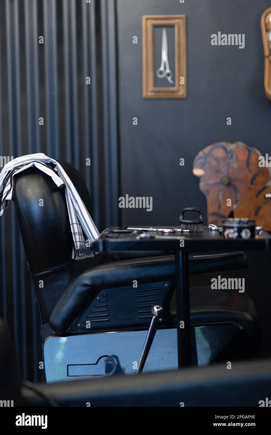 Barber room with apron and table with shaving instruments Stock Photo ...