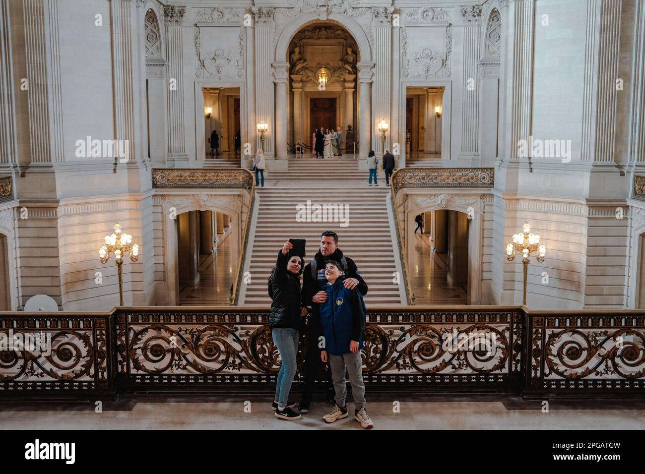 People take pictures infront of the grand staircase inside City Hall ...