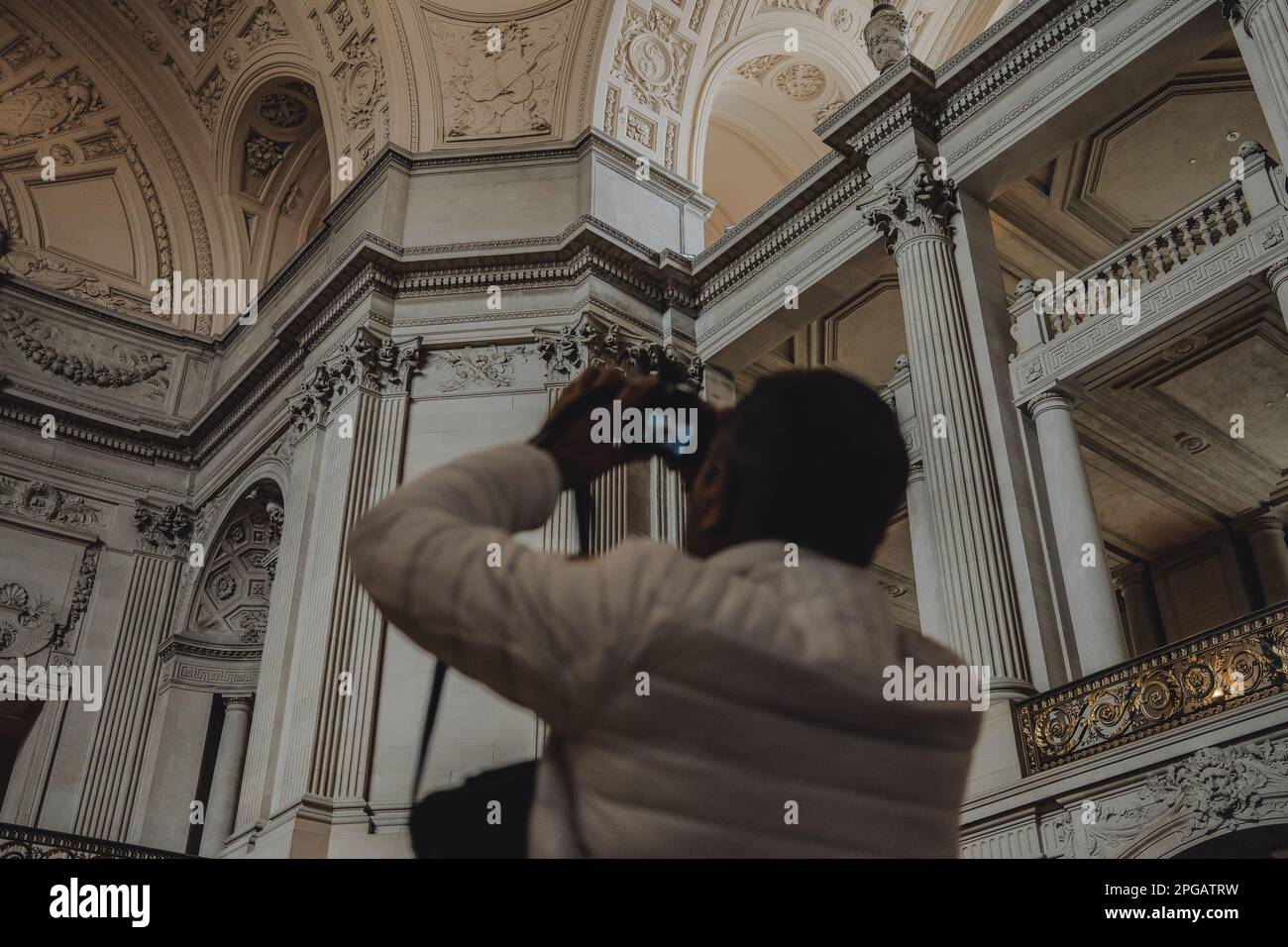 A man takes a shot of the City Hall's impressive rotunda, which ...