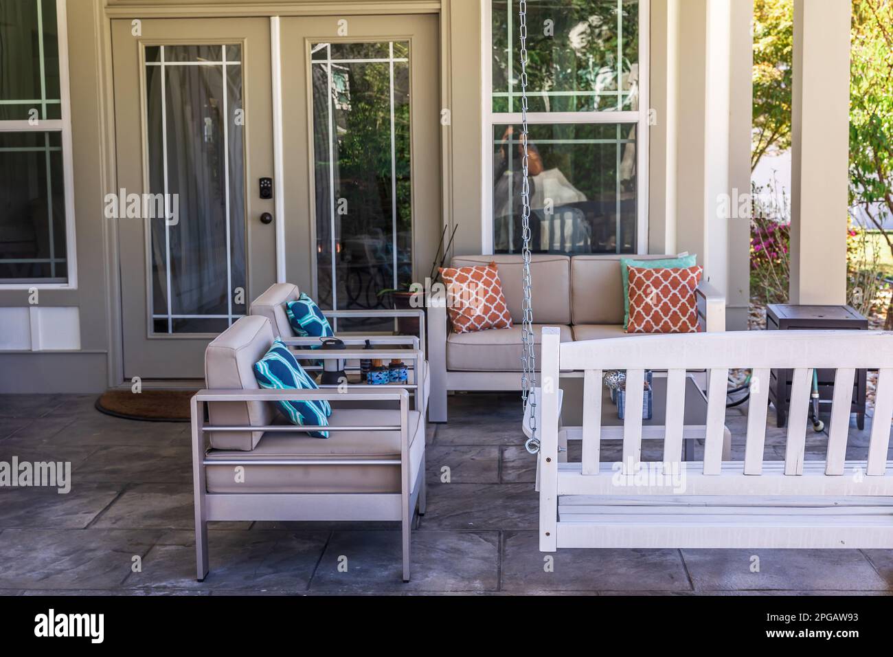 Covered outdoor patio in a new construction house home with guest ...