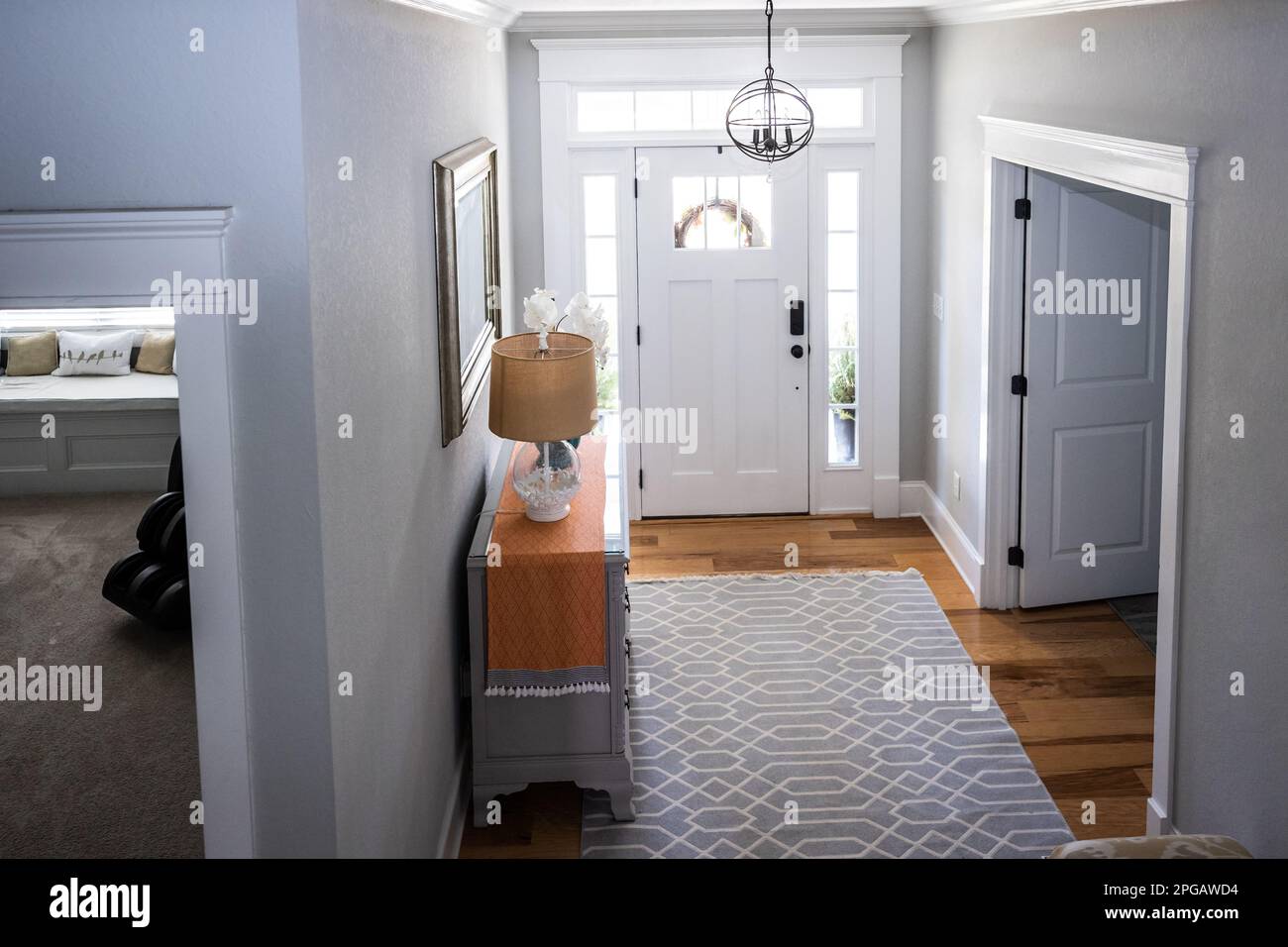 An open large and wide interior front door hallway foyer with transom ...