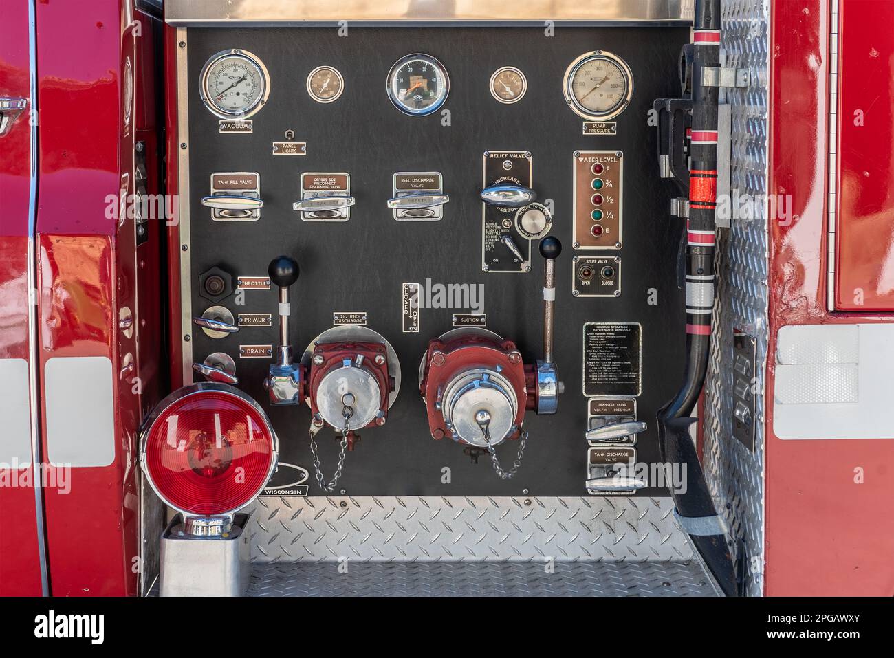 Close up view of rear fire truck has controls for discharge, drain ...