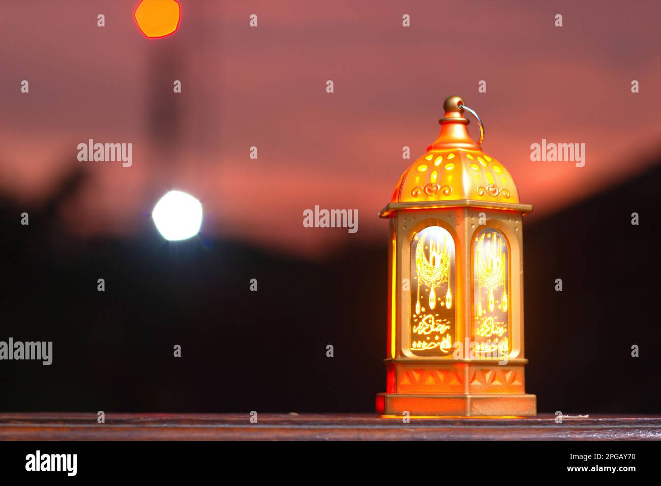 Decorative Arabic lanterns with burning candles at night. Glittering ...