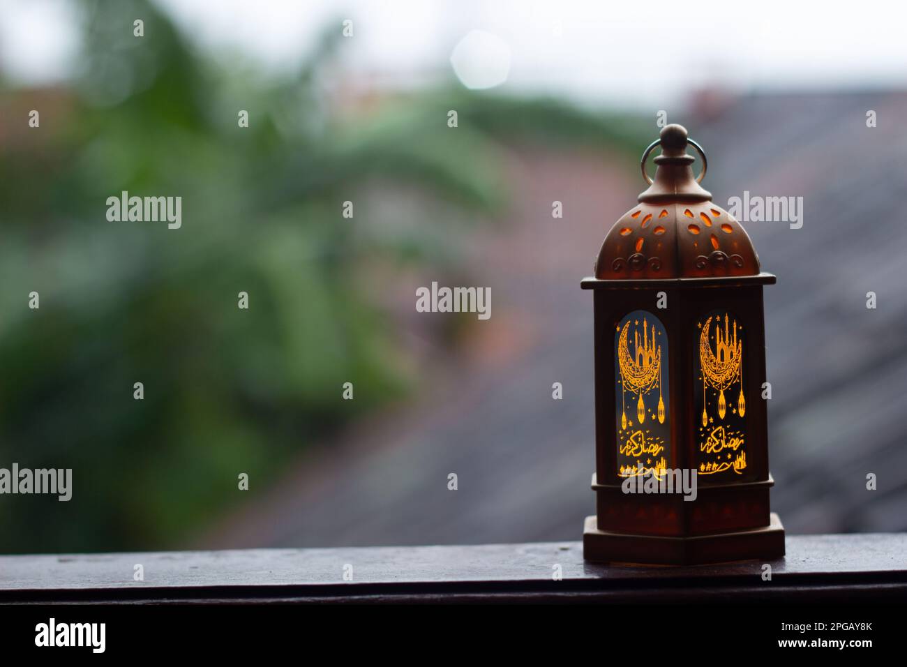 Decorative Arabic lanterns with burning candles at night. Glittering ...