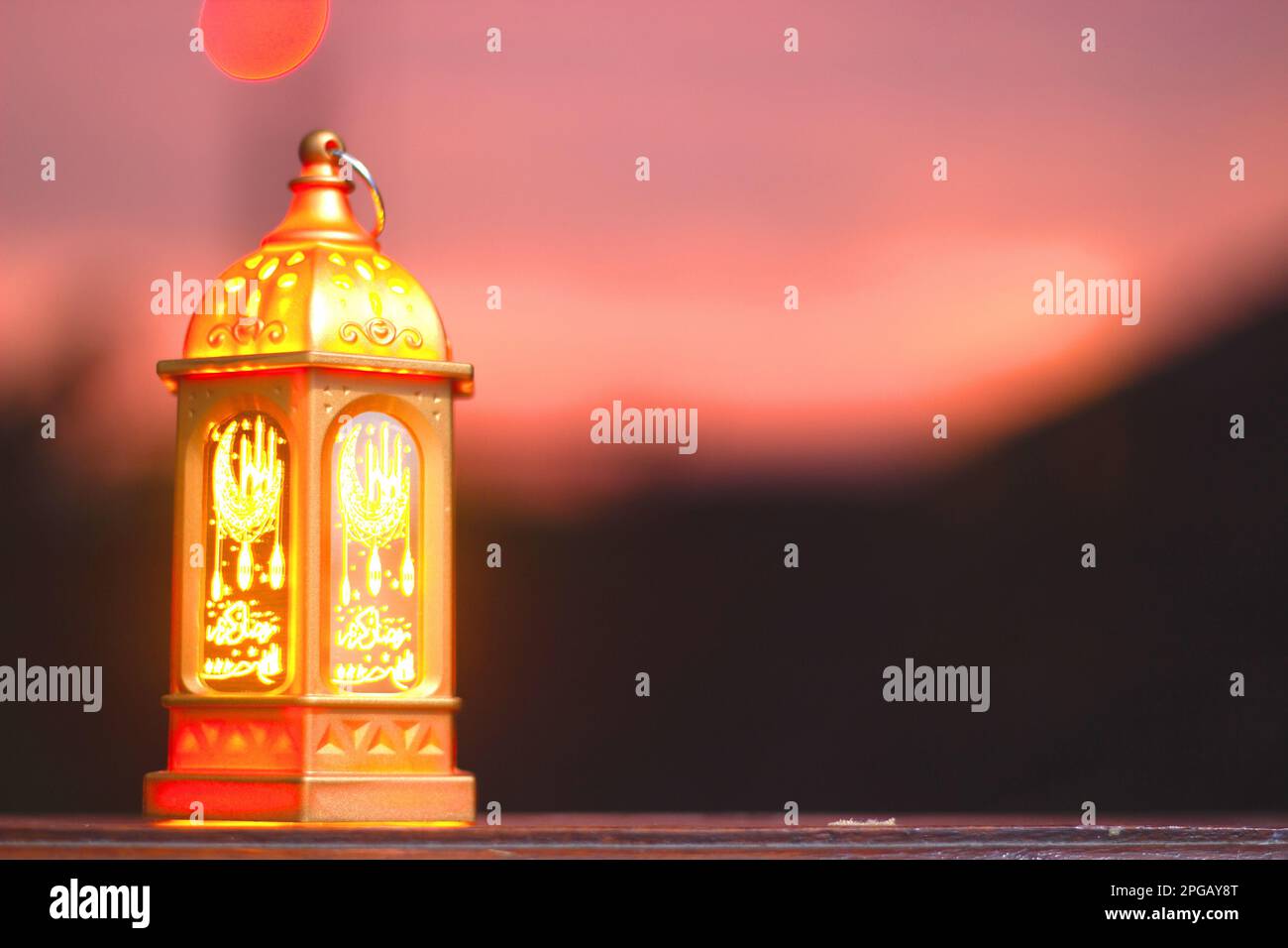 Decorative Arabic lanterns with burning candles at night. Glittering ...