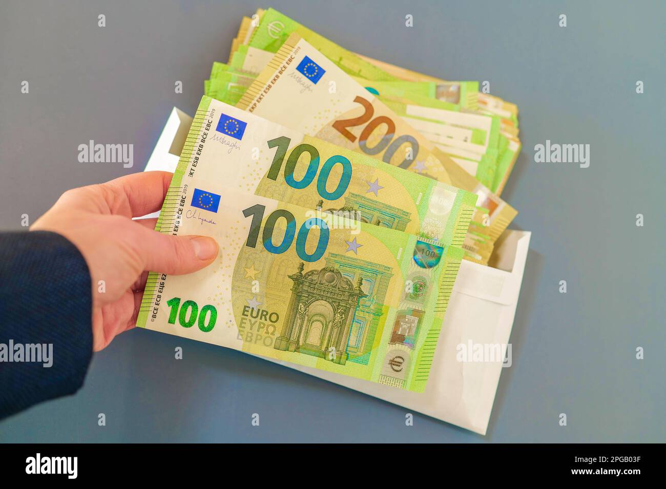 euro bills in an envelope.hand sorting out Euro bills in an envelope ...