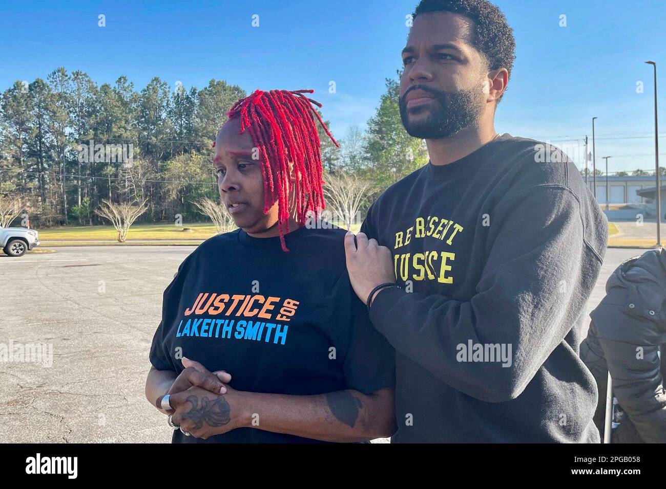 Daniel Forkkio, left, of the advocacy group Represent Justice, comforts ...