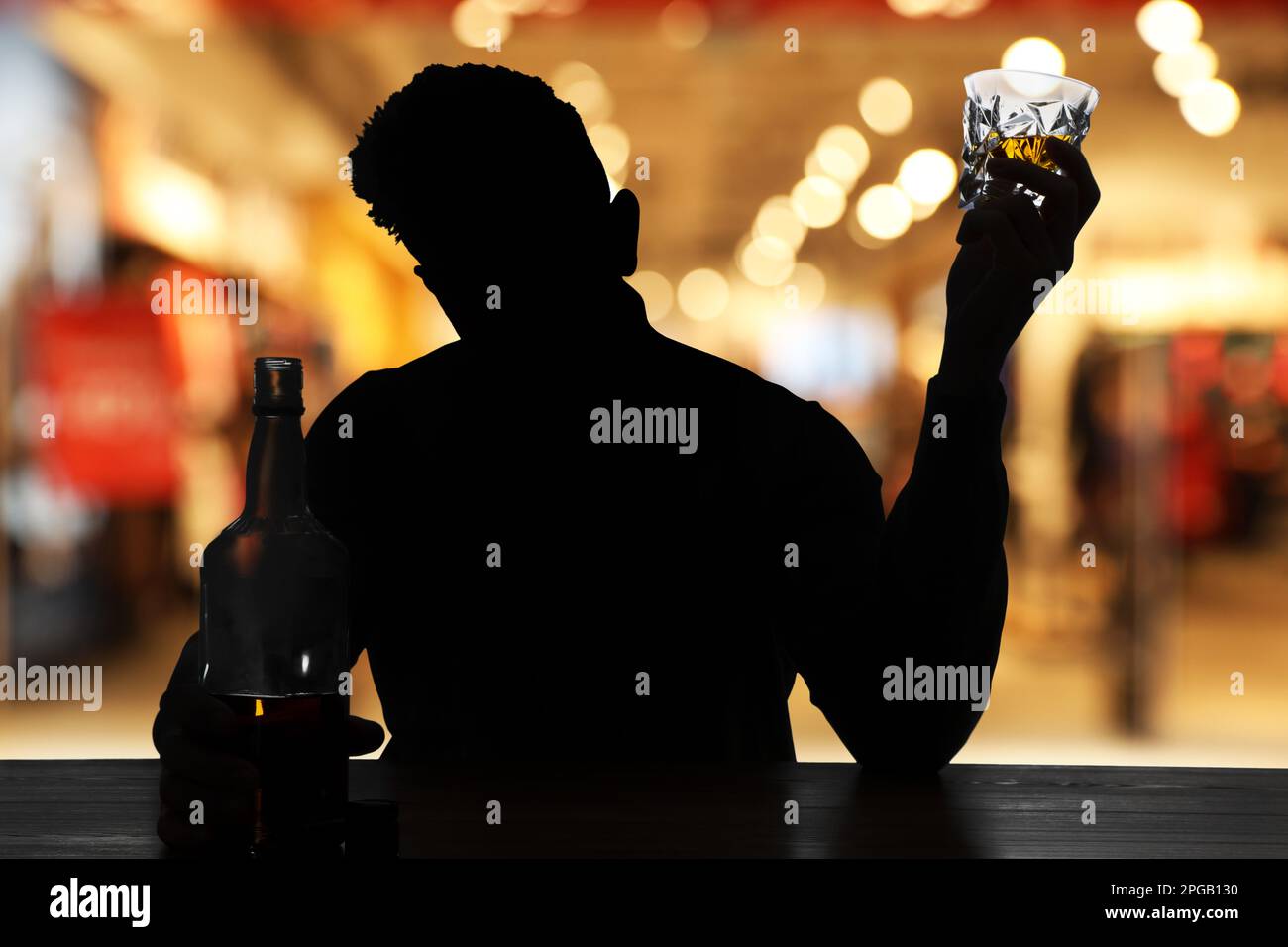 Silhouette of addicted man with alcoholic drink in bar Stock Photo - Alamy