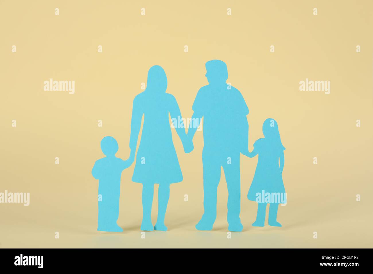 Paper family figure on beige background. Child adoption concept Stock ...