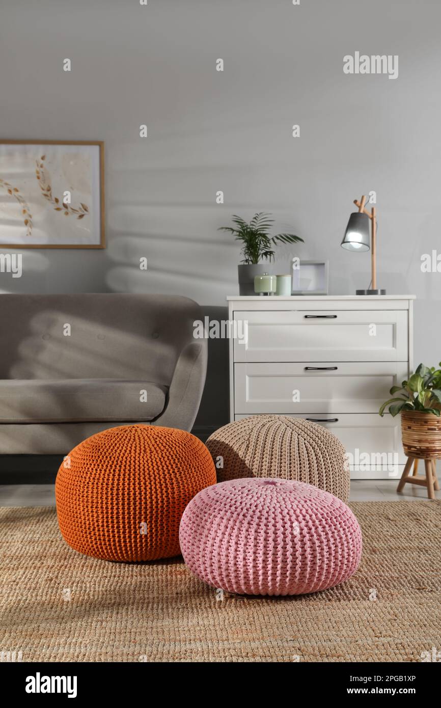 Stylish knitted poufs and sofa in living room. Home design Stock Photo ...