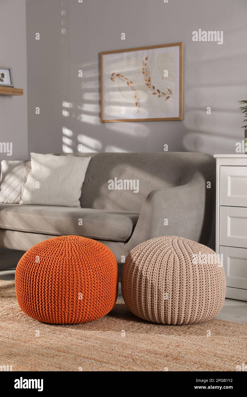 Stylish knitted poufs and sofa in living room. Home design Stock Photo ...