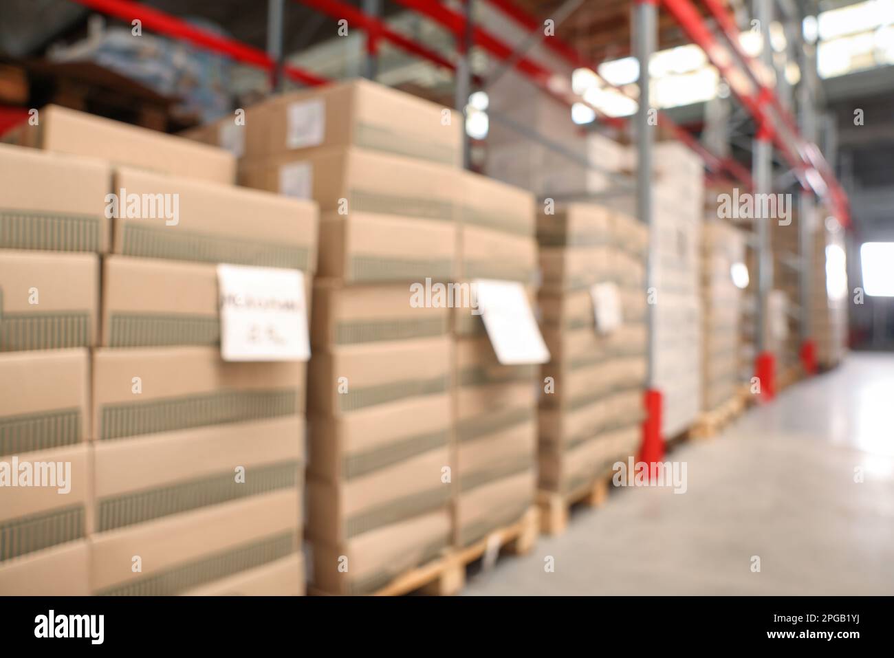 Blurred view of warehouse with boxes. Wholesaling Stock Photo - Alamy